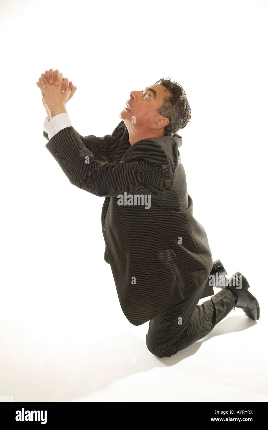 Kneeling businessman praying for mercy Stock Photo: 17172685 - Alamy