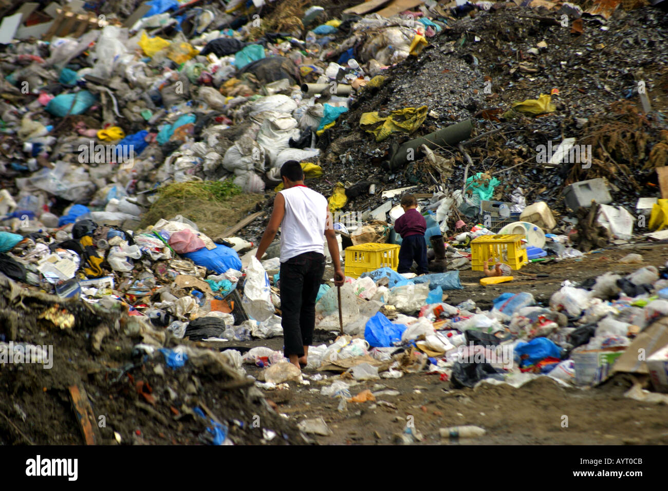 Yong gipsy and little kid look for usefull things at dump Stock Photo ...