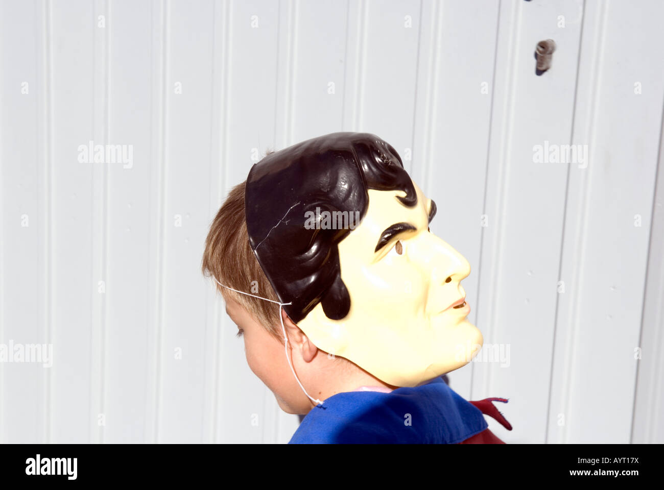 detail of young boy wearing a superman mask back to front on his head ...