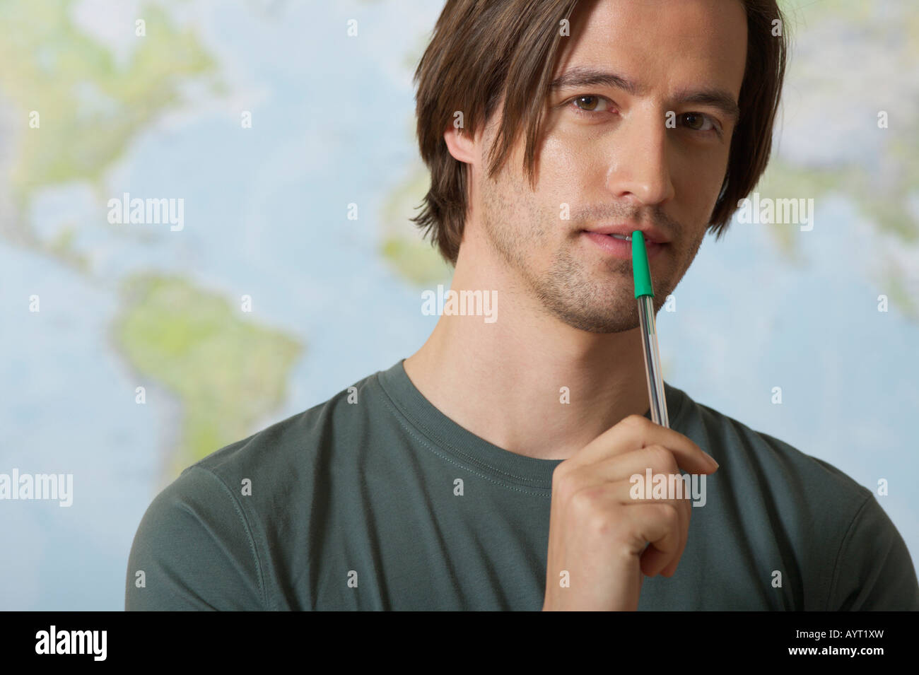 A man standing in front of a world map Stock Photo - Alamy