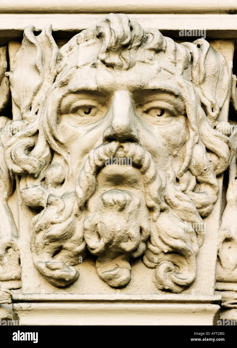 Stone face, ornate stonework on old building facade in the old part of ...