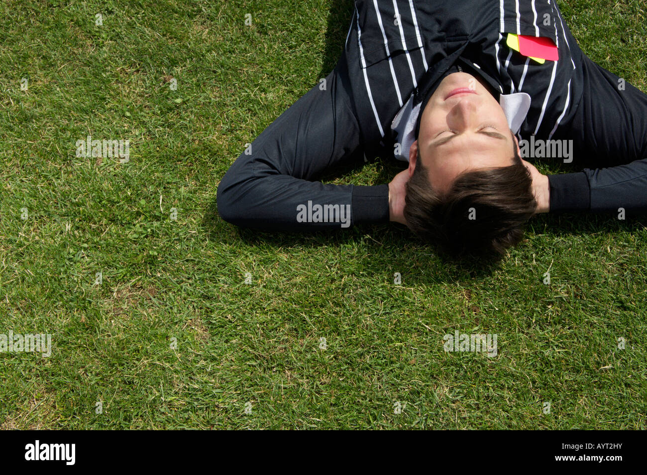 Relaxed referee lying on soccer field Stock Photo - Alamy