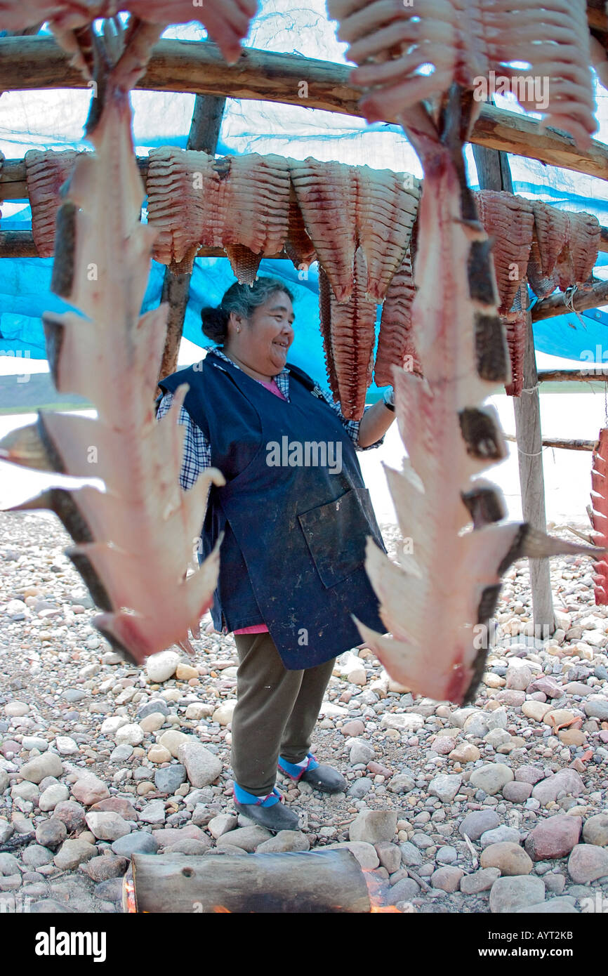 Elder Inuit woman with dried fish in smoke tent Stock Photo - Alamy