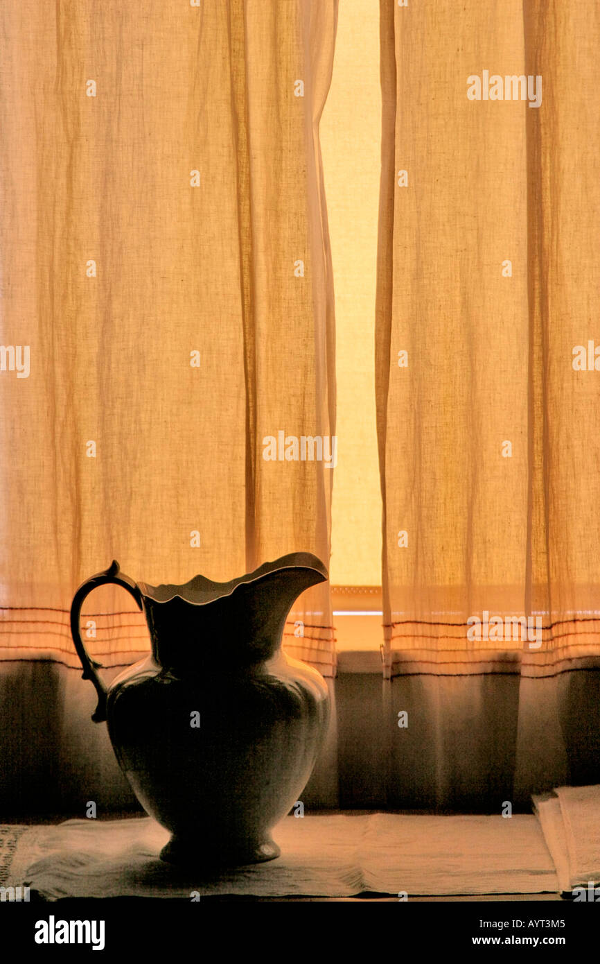pitcher silhouetted in window Stock Photo - Alamy