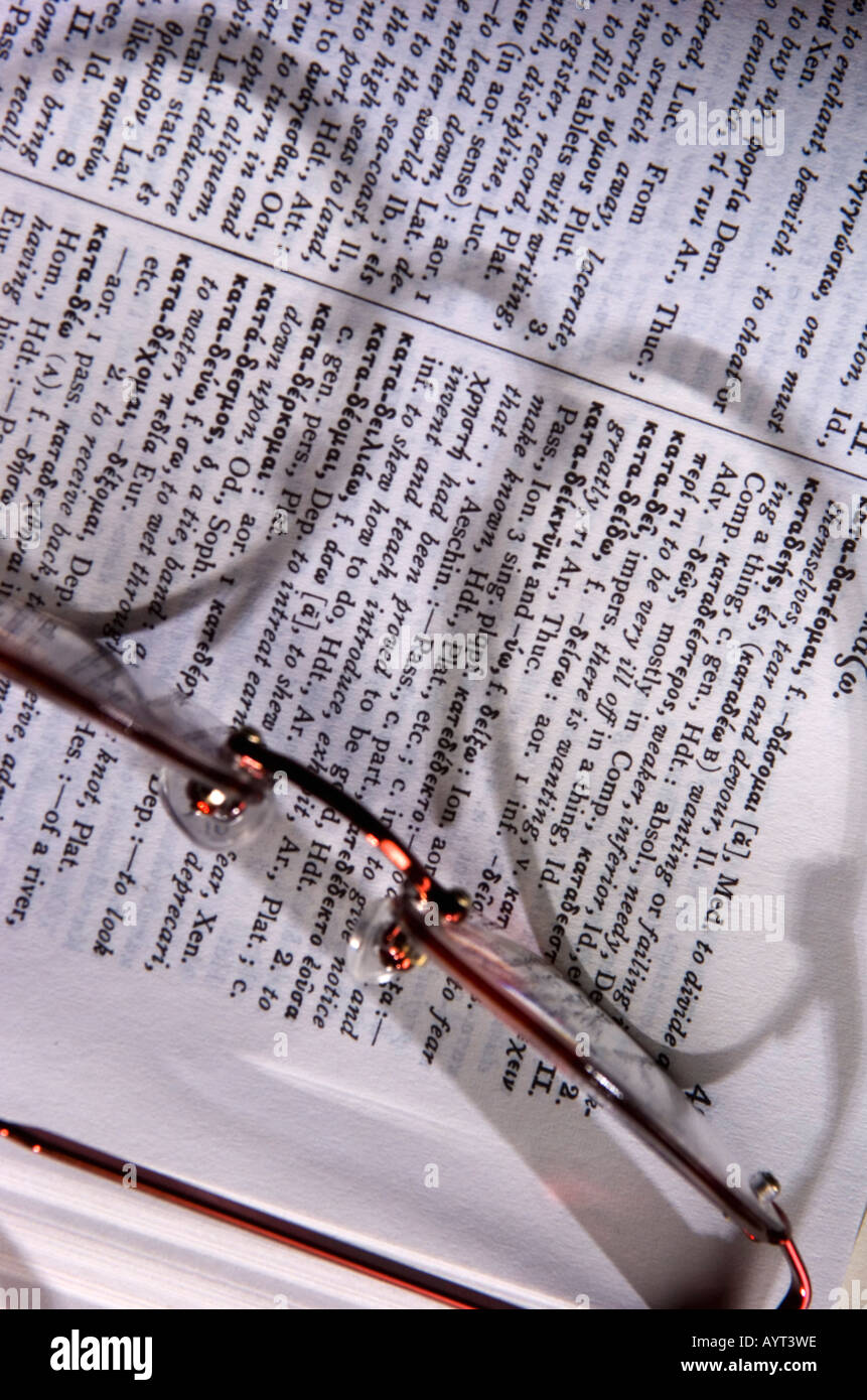 eyeglasses on a book Stock Photo - Alamy