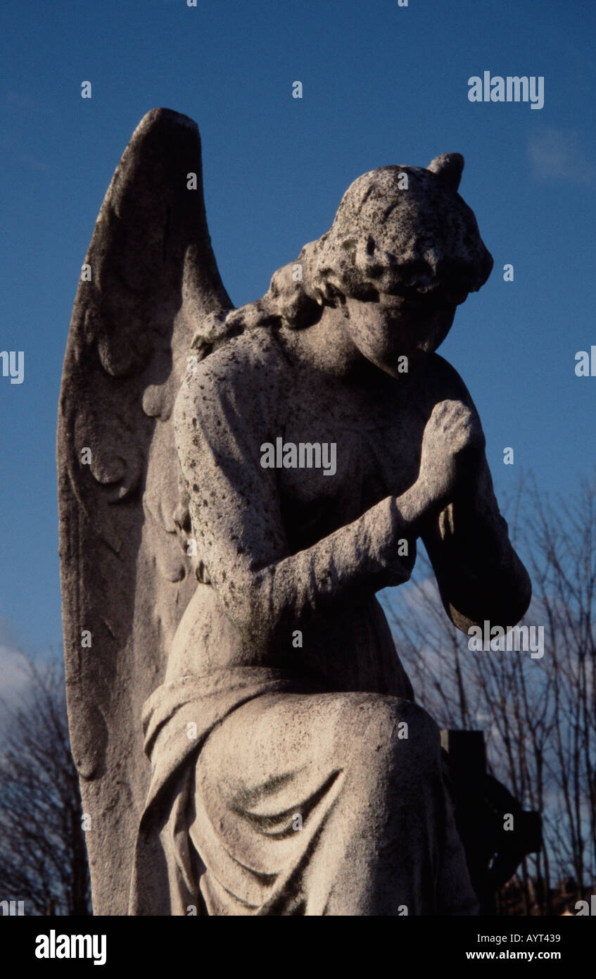 Statue of an angel praying in Kensal Green Cemetery, London England UK ...