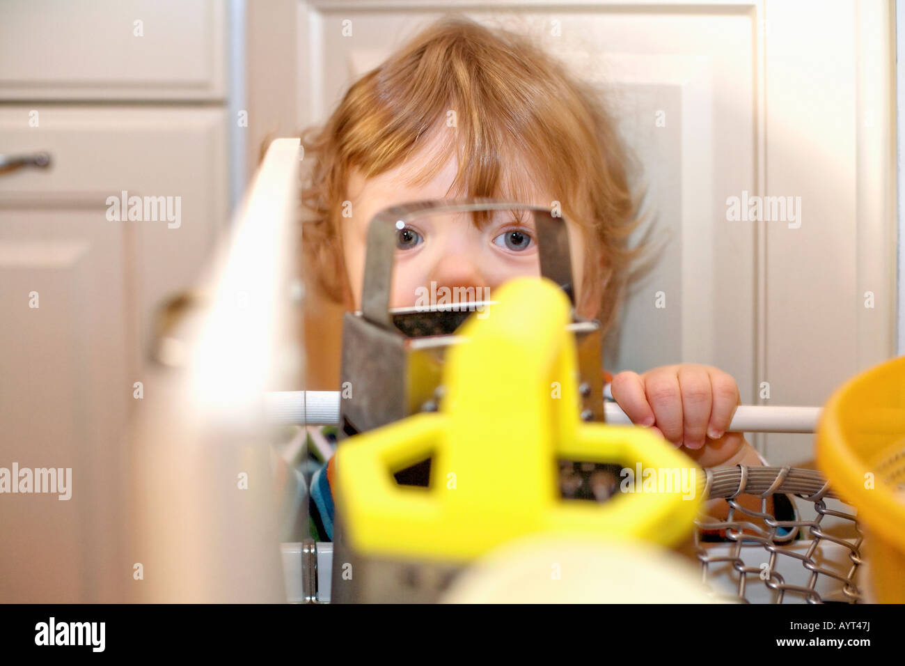 BOY OPENING DRAWER IN THE KITCHEN Stock Photo - Alamy