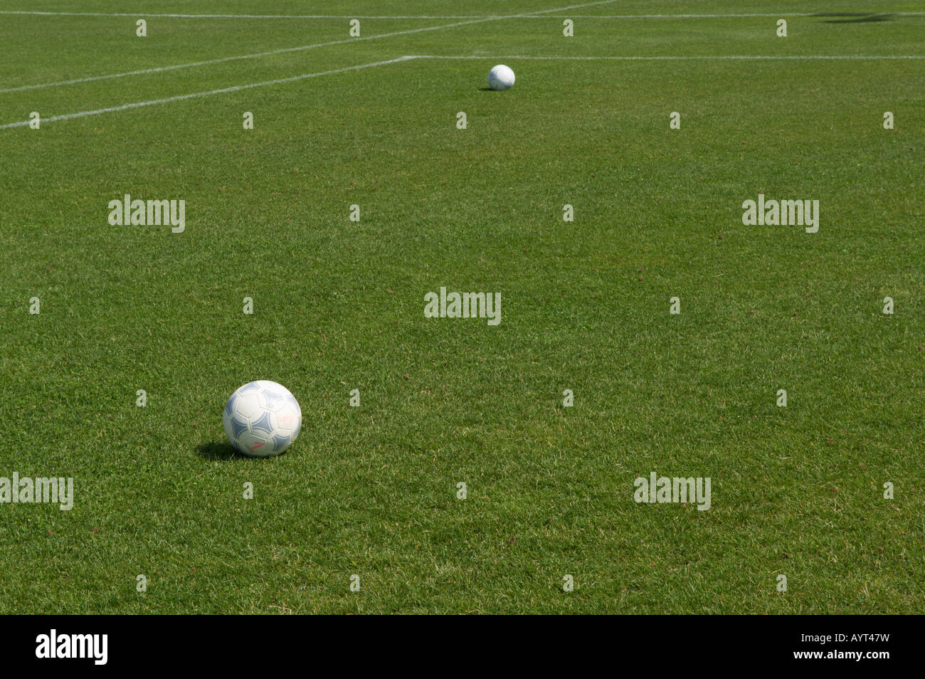 Balls on soccer field Stock Photo - Alamy