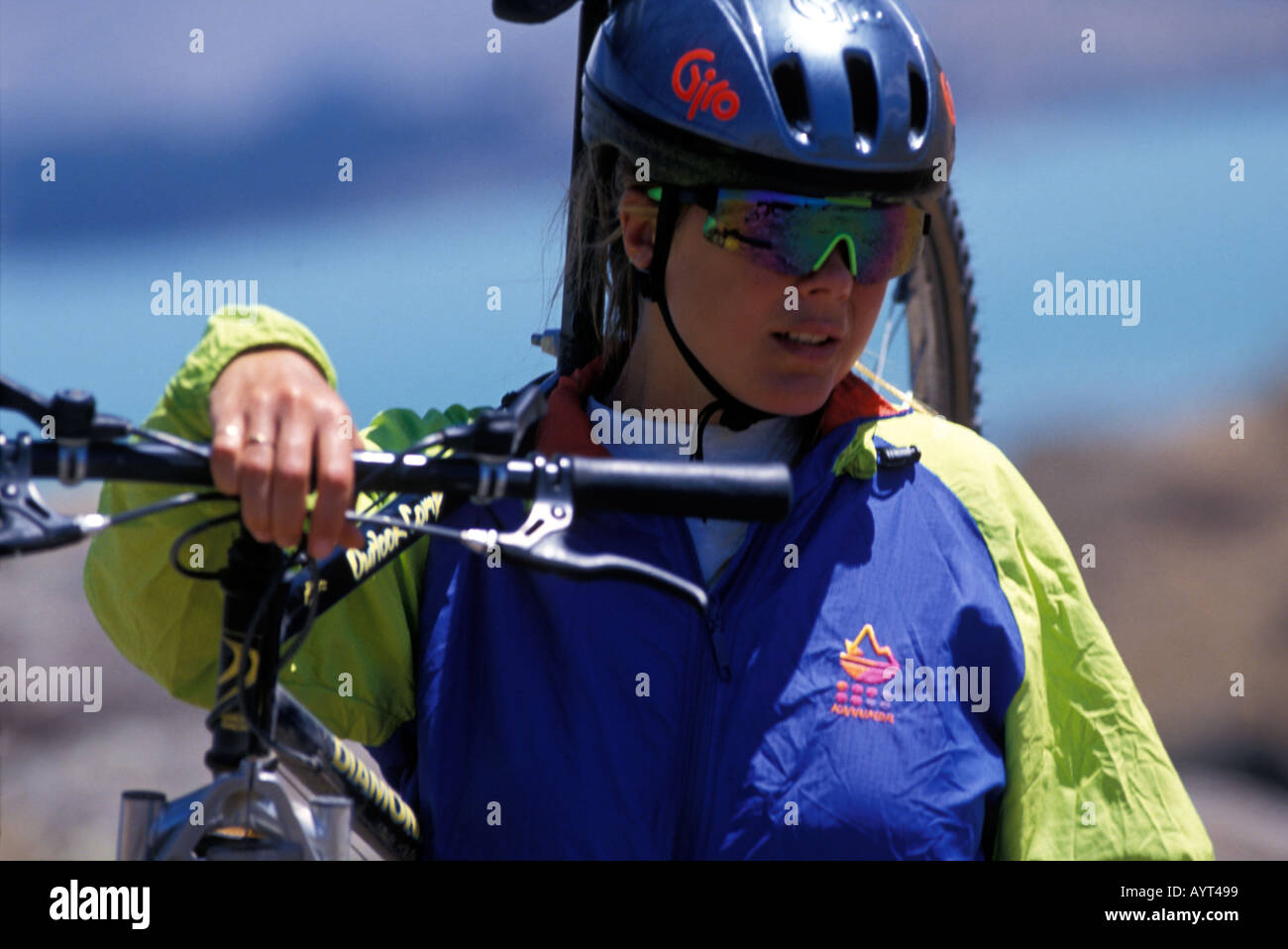 Female cyclist carrying bike over her shoulder Stock Photo - Alamy
