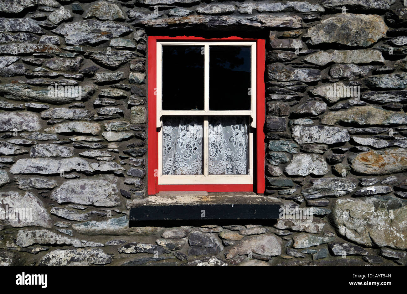 red painted wooden window frame in front of a traditional typical old ...