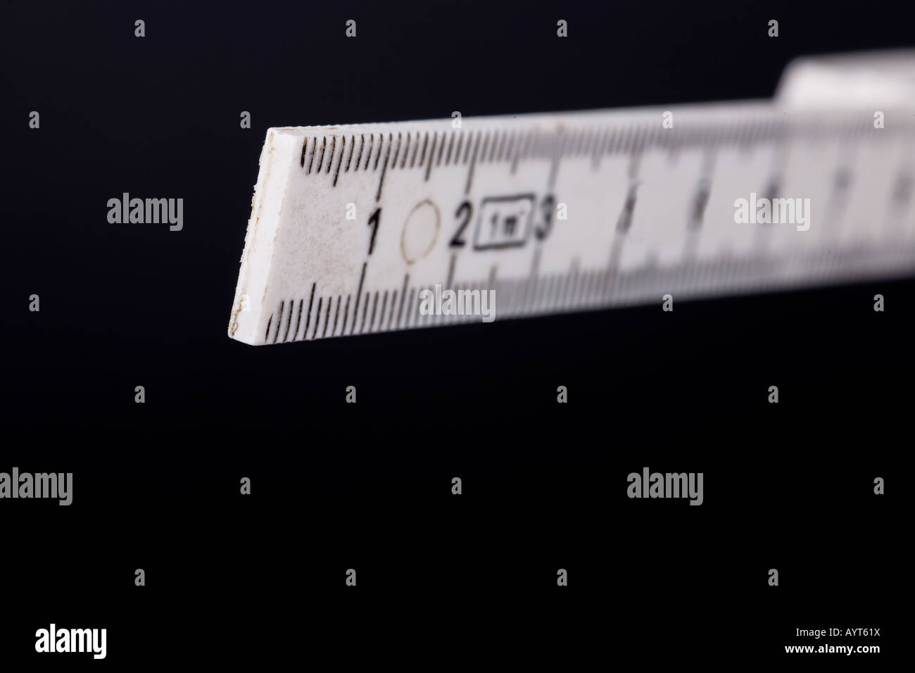 Folding rule on black background Stock Photo - Alamy