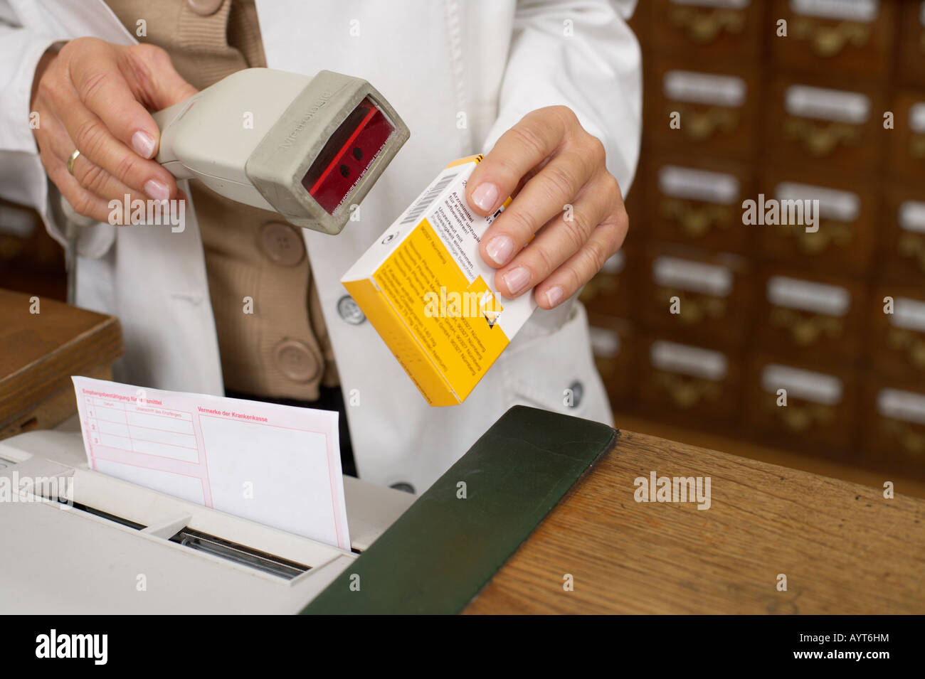 Female pharmacist scanning drug at cash register Stock Photo - Alamy
