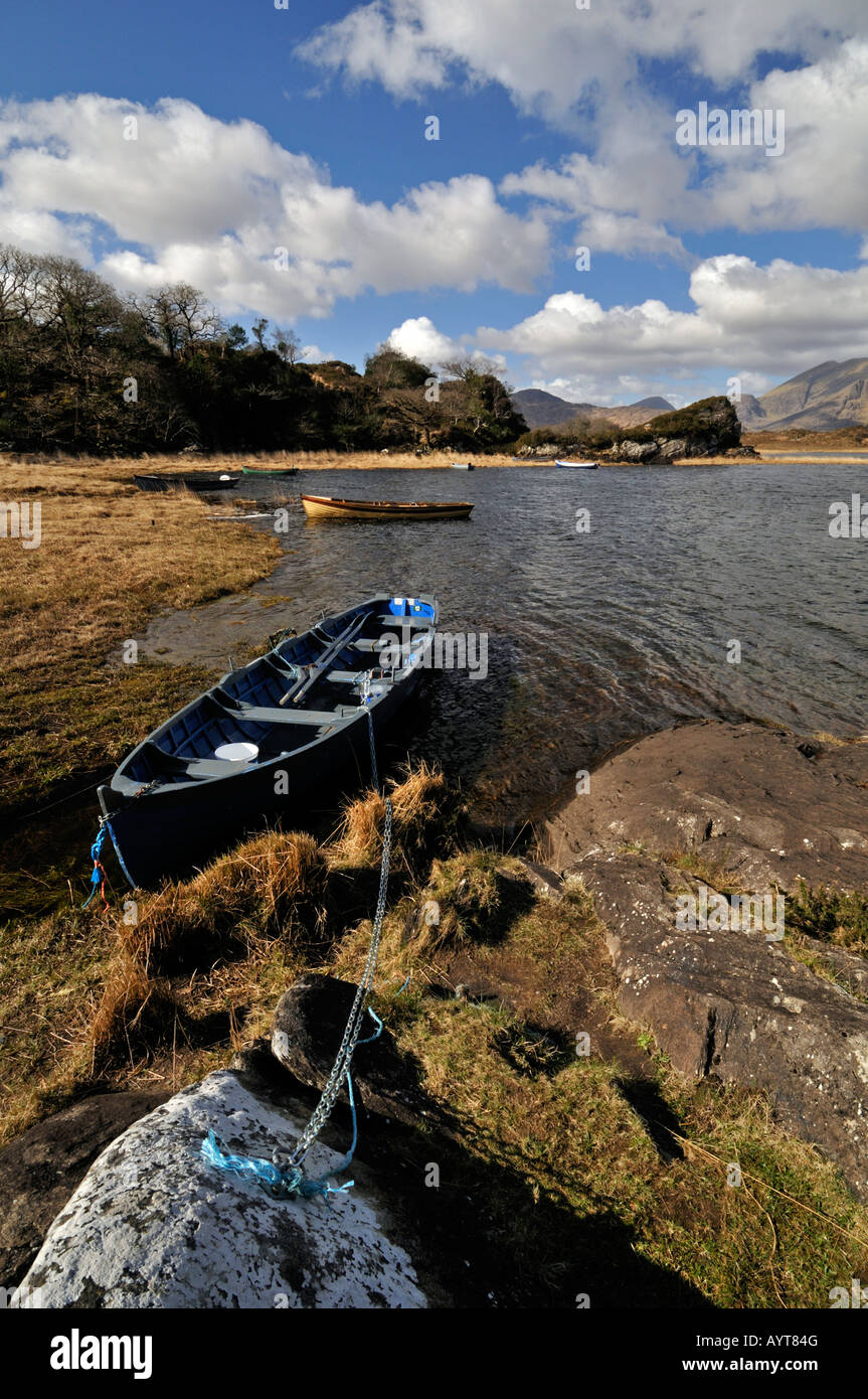 The Upper Lake Killarney blue sky white clouds blue grey fishing boat ...