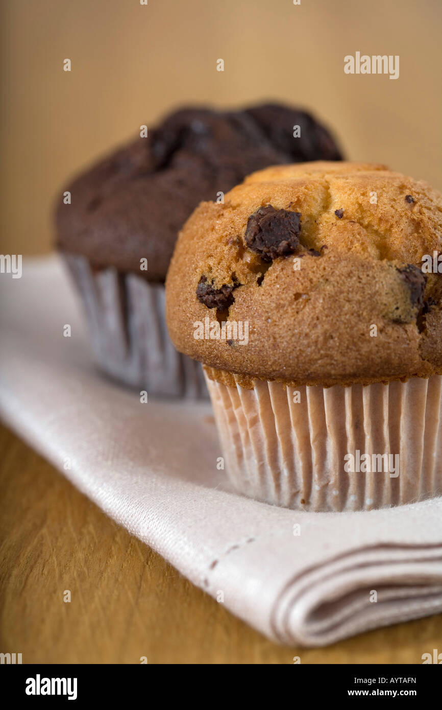 Two Muffins lying on a table napkin Stock Photo - Alamy