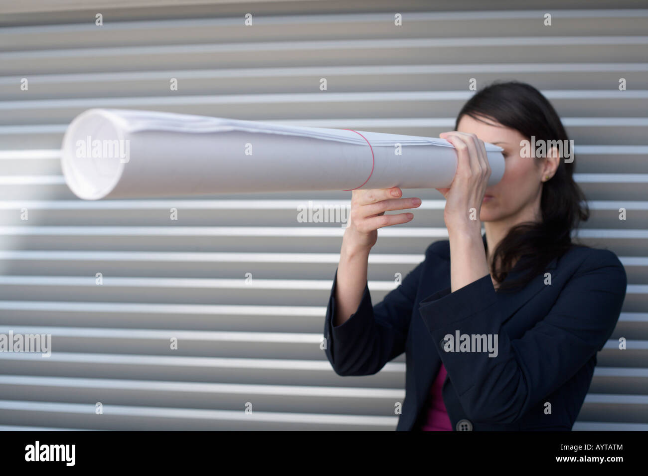 Woman looking through paper roll hi-res stock photography and images ...