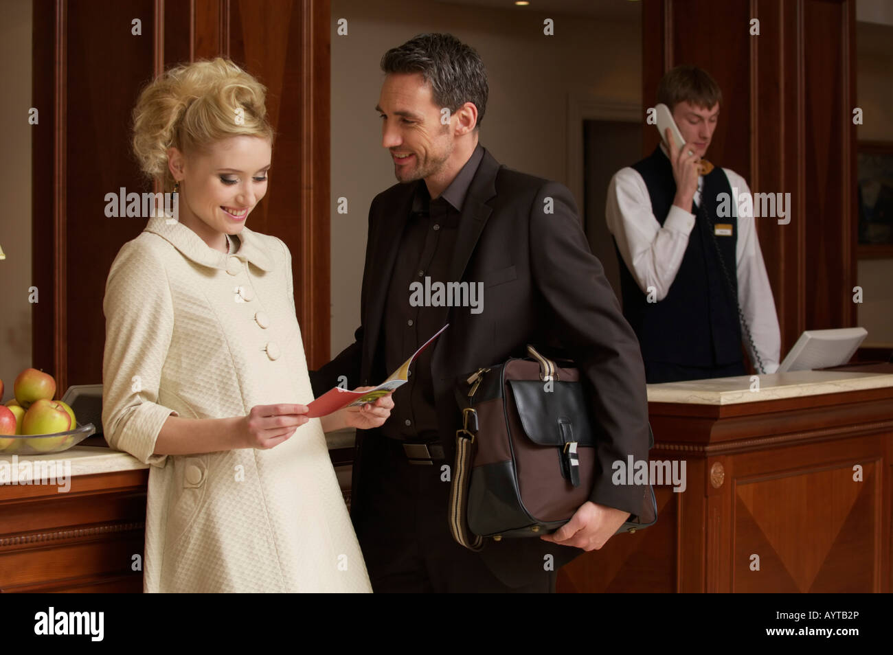 Couple standing at a hotel reception Stock Photo - Alamy