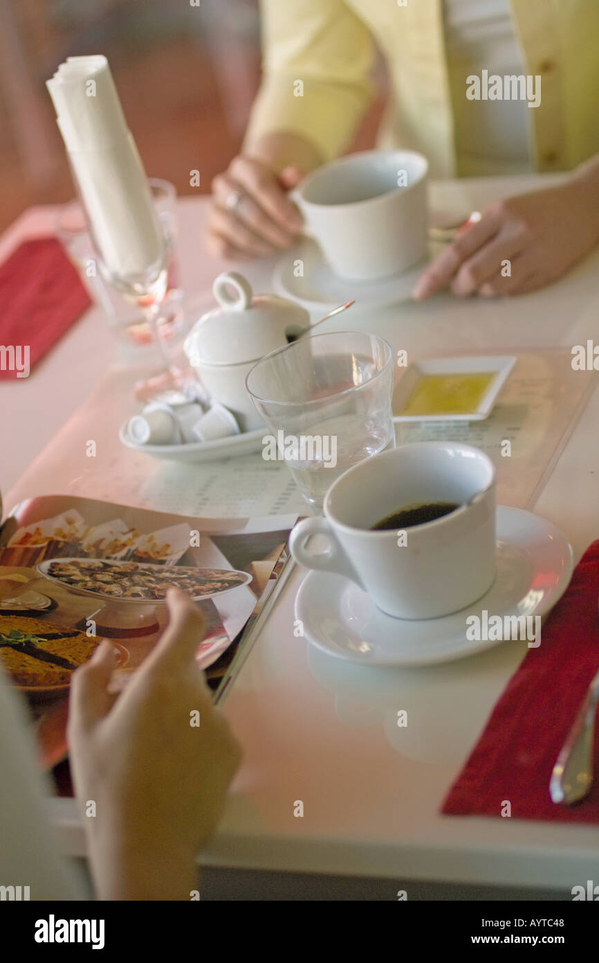 Table with cups of coffee Stock Photo - Alamy