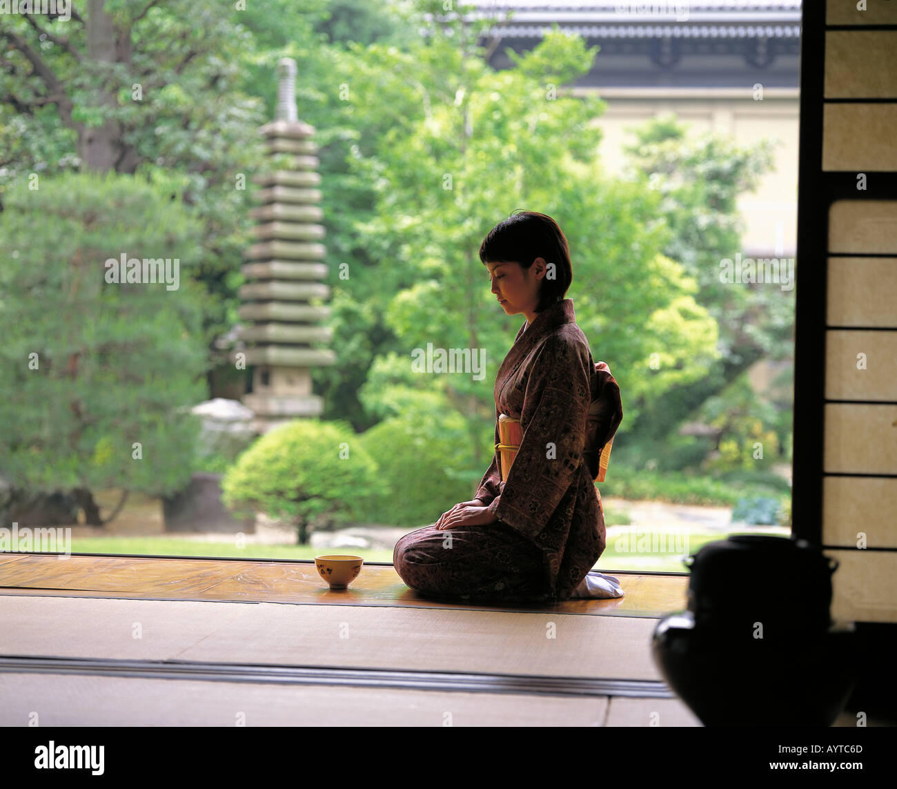 Young woman sitting on the porch of Japanese style house Stock Photo ...