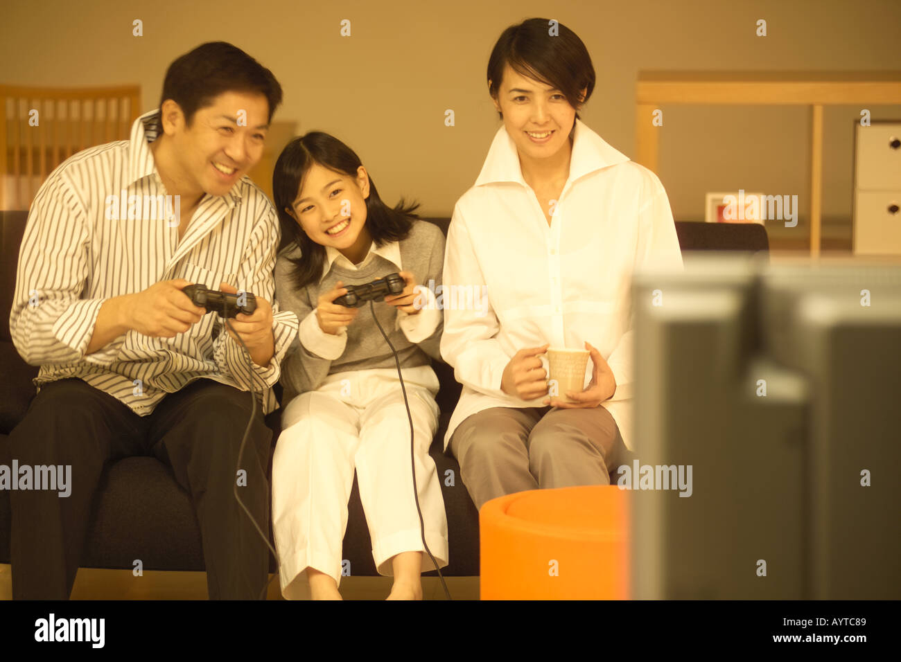 Family playing computer game Stock Photo - Alamy