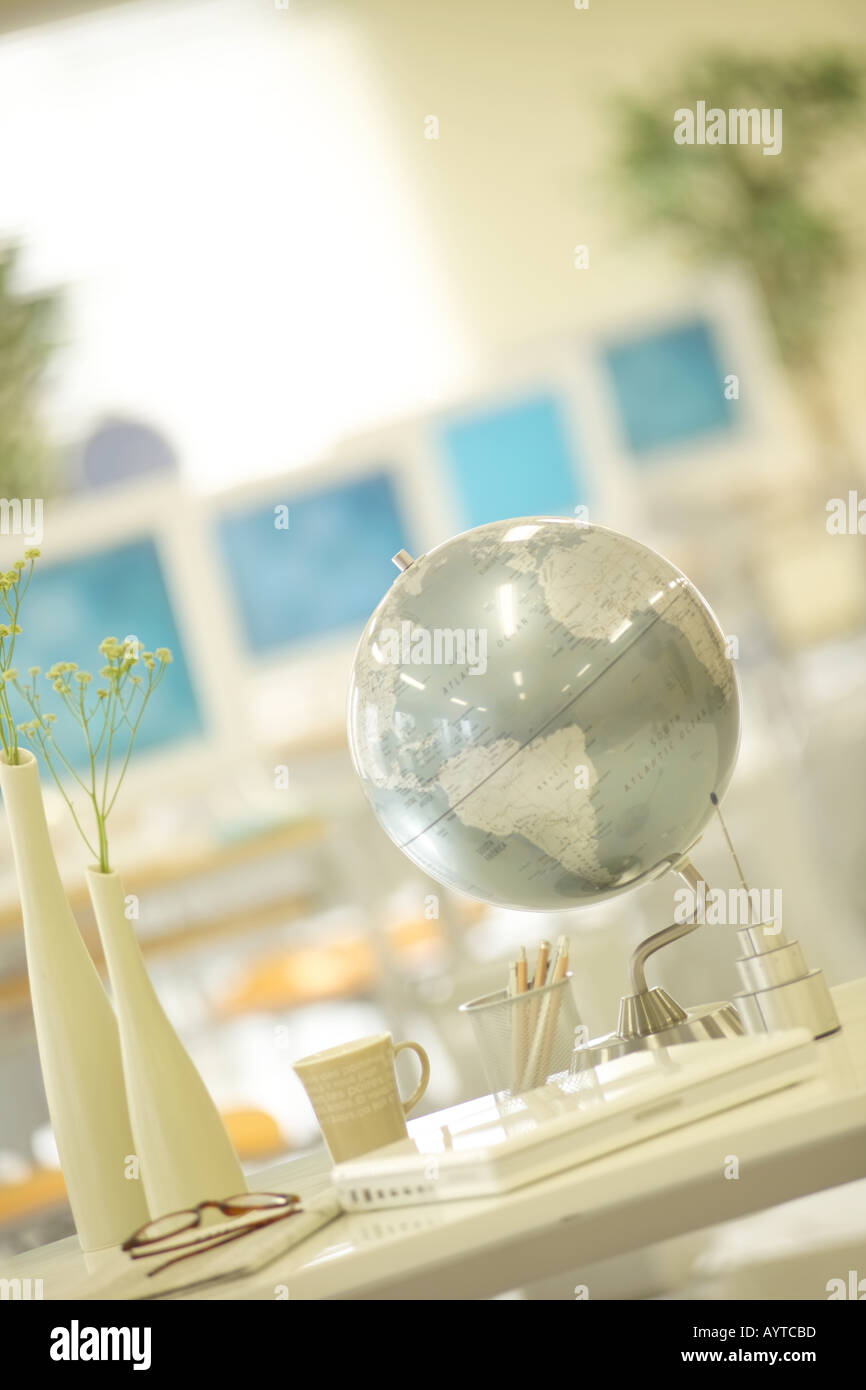 Globe and laptop computer on the desk Stock Photo - Alamy