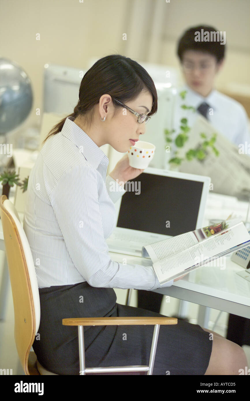 Young office woman taking a break by the computer Stock Photo - Alamy