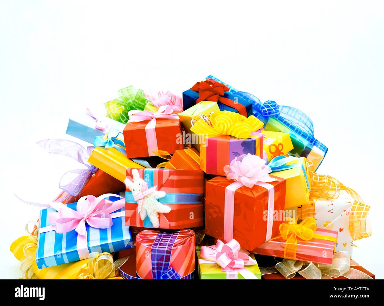 Pile of presents wrapped in different color giftwrap Stock Photo - Alamy
