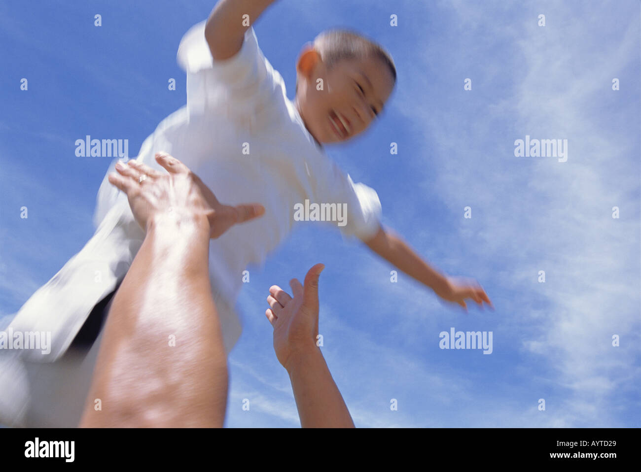 Hands throwing a boy in the air Stock Photo - Alamy