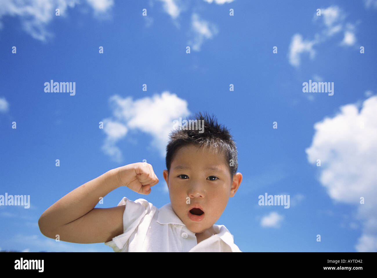 A boy flexing his muscle Stock Photo - Alamy