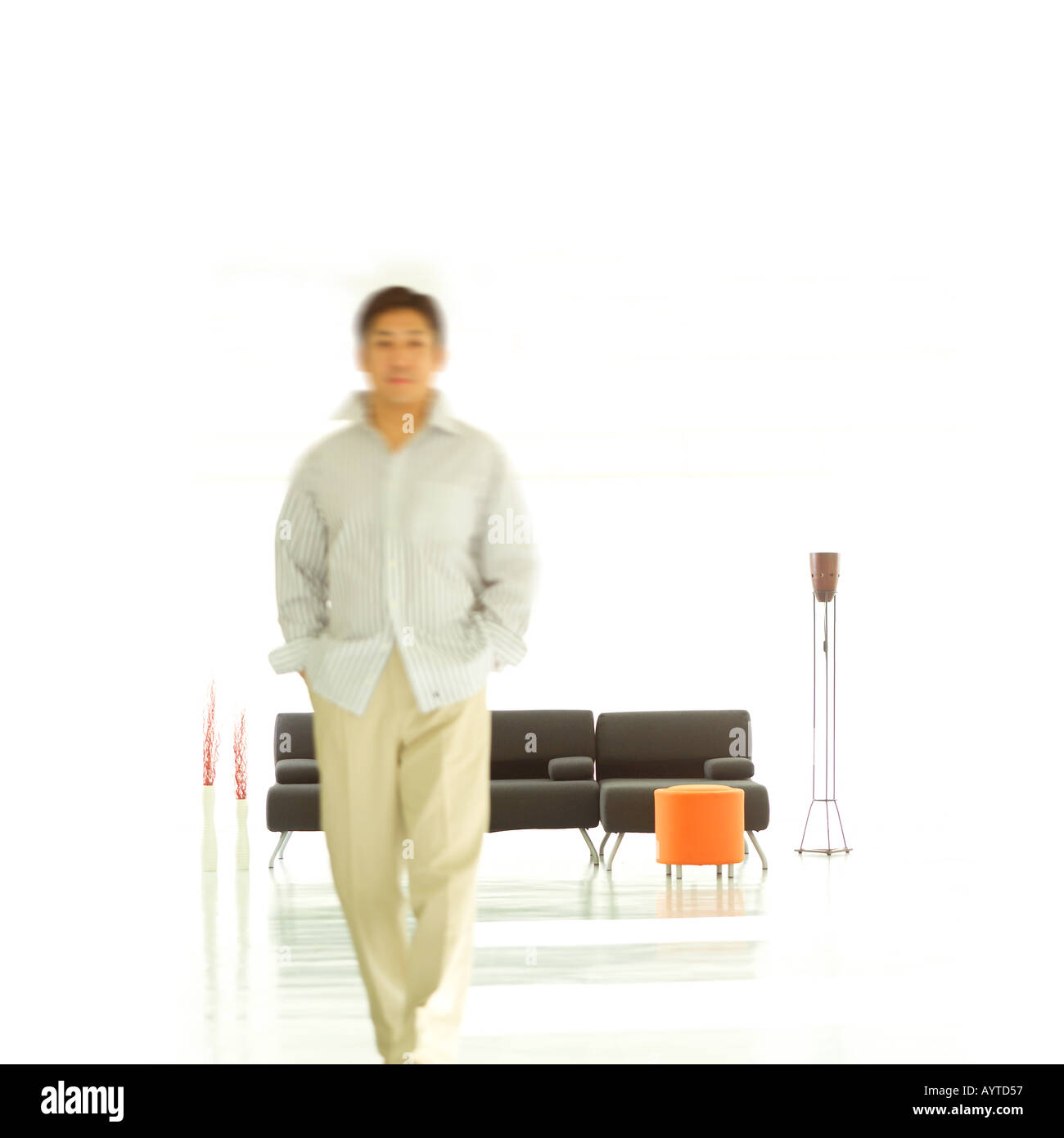 Man walking in a living room Stock Photo - Alamy