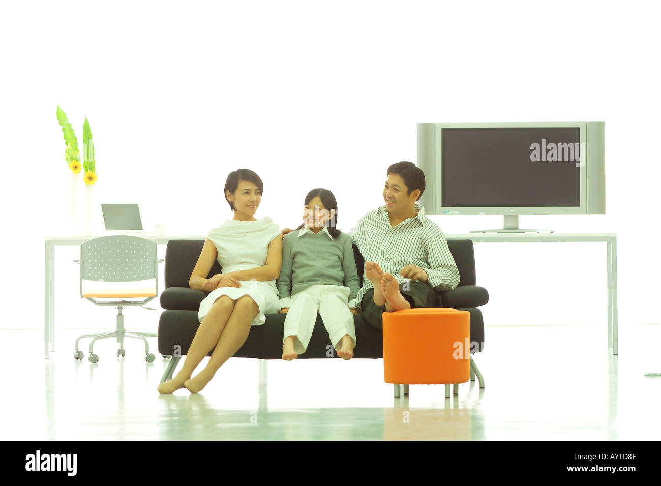 Family in a modern living room Stock Photo - Alamy