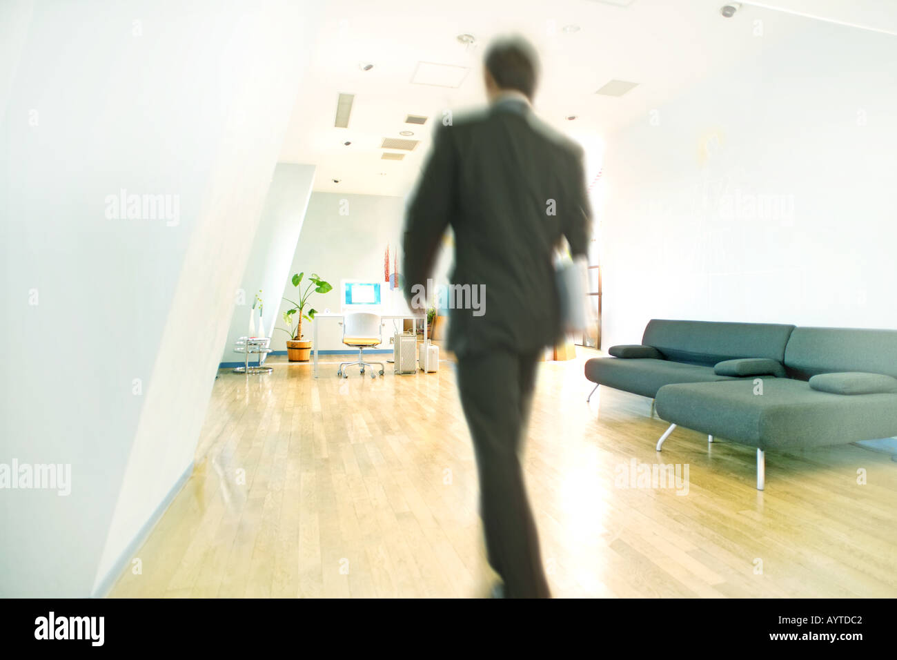 Man in business suit walking in the small office Stock Photo - Alamy