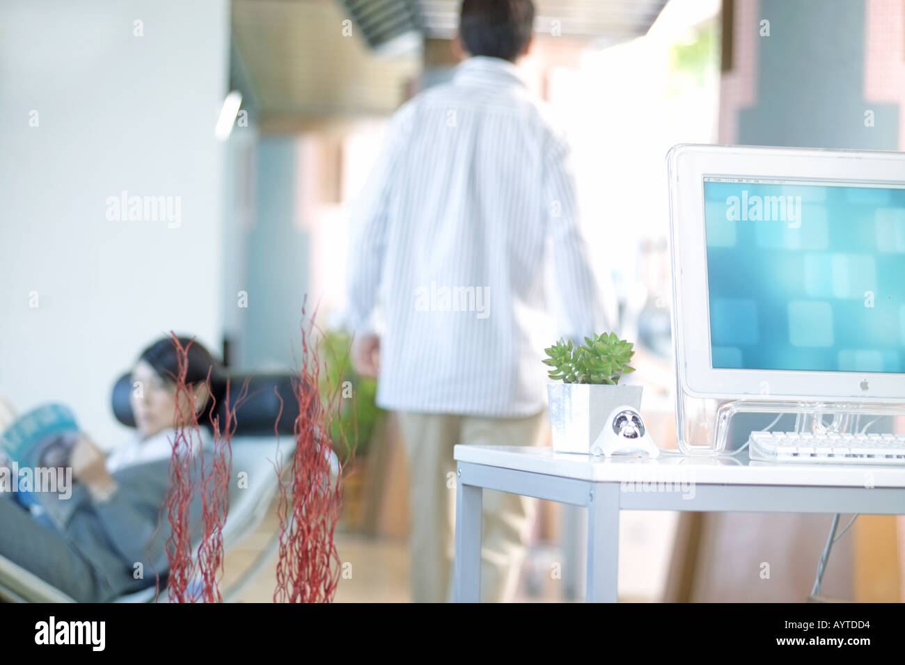 Couple in a modern living room with computer screen Stock Photo - Alamy