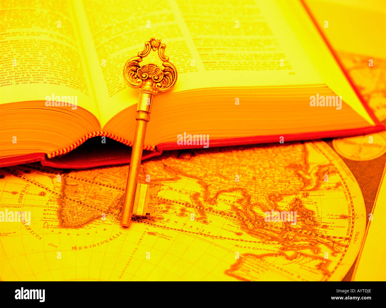 Close up on an open book with a golden key and a world map Stock Photo ...
