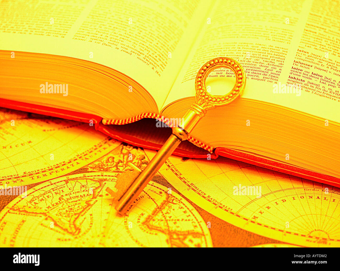 Gold key on top of open book with a world map Stock Photo - Alamy