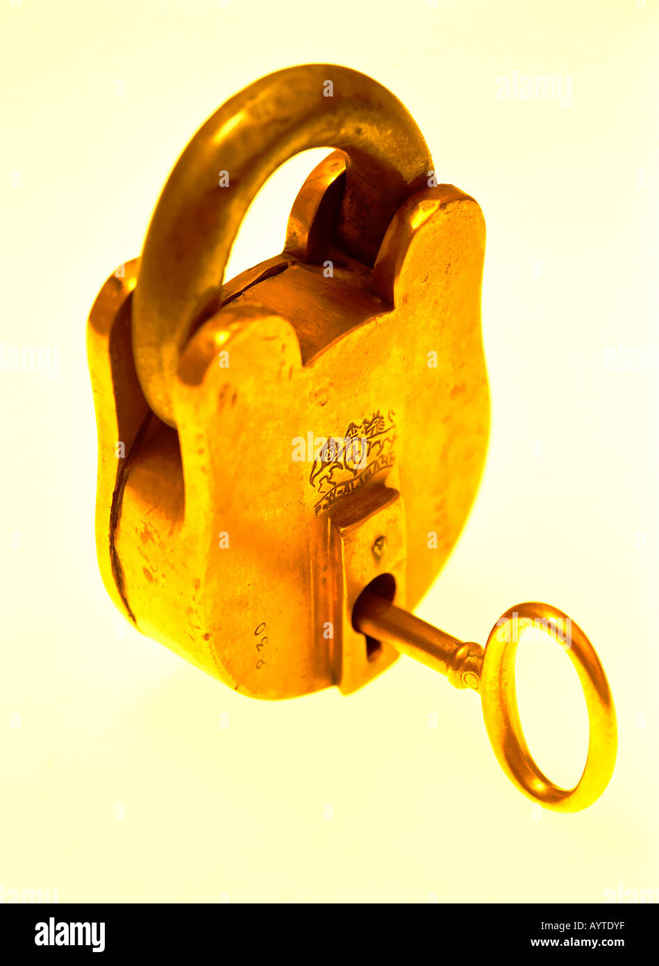 A golden locket with a key Stock Photo - Alamy