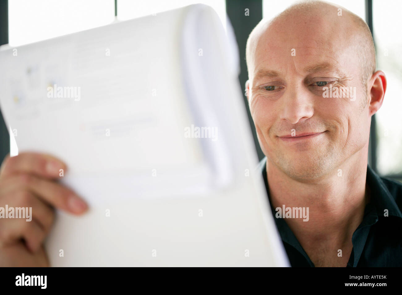 Mature man reading a document Stock Photo - Alamy