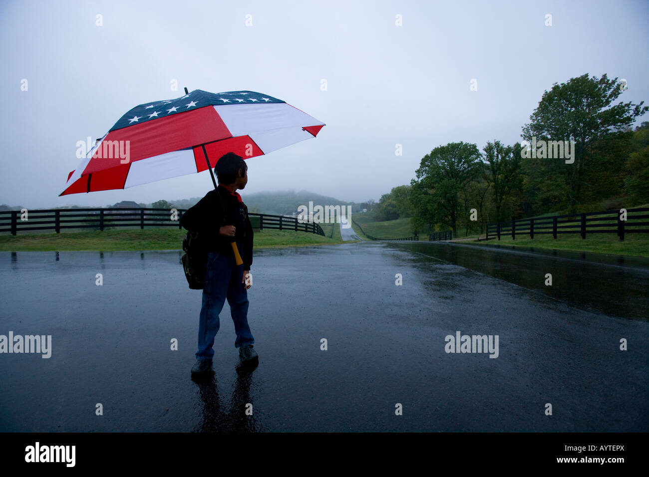 Waiting for the school bus in the rain Stock Photo - Alamy