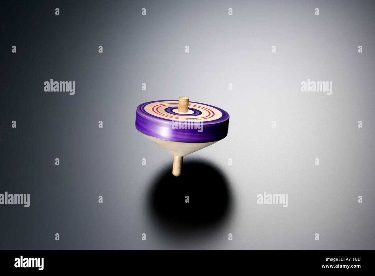 Spinning top spinning with a black background Stock Photo - Alamy