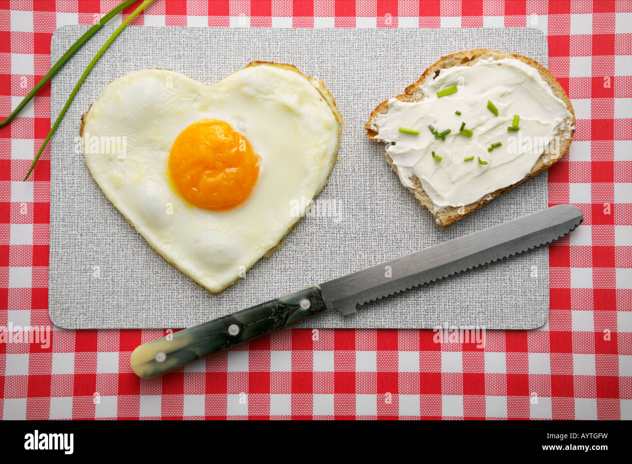 Heart-shaped fried egg and a bread with cream cheese Stock Photo - Alamy