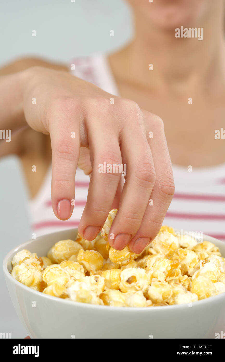 Woman eating popcorn Stock Photo - Alamy