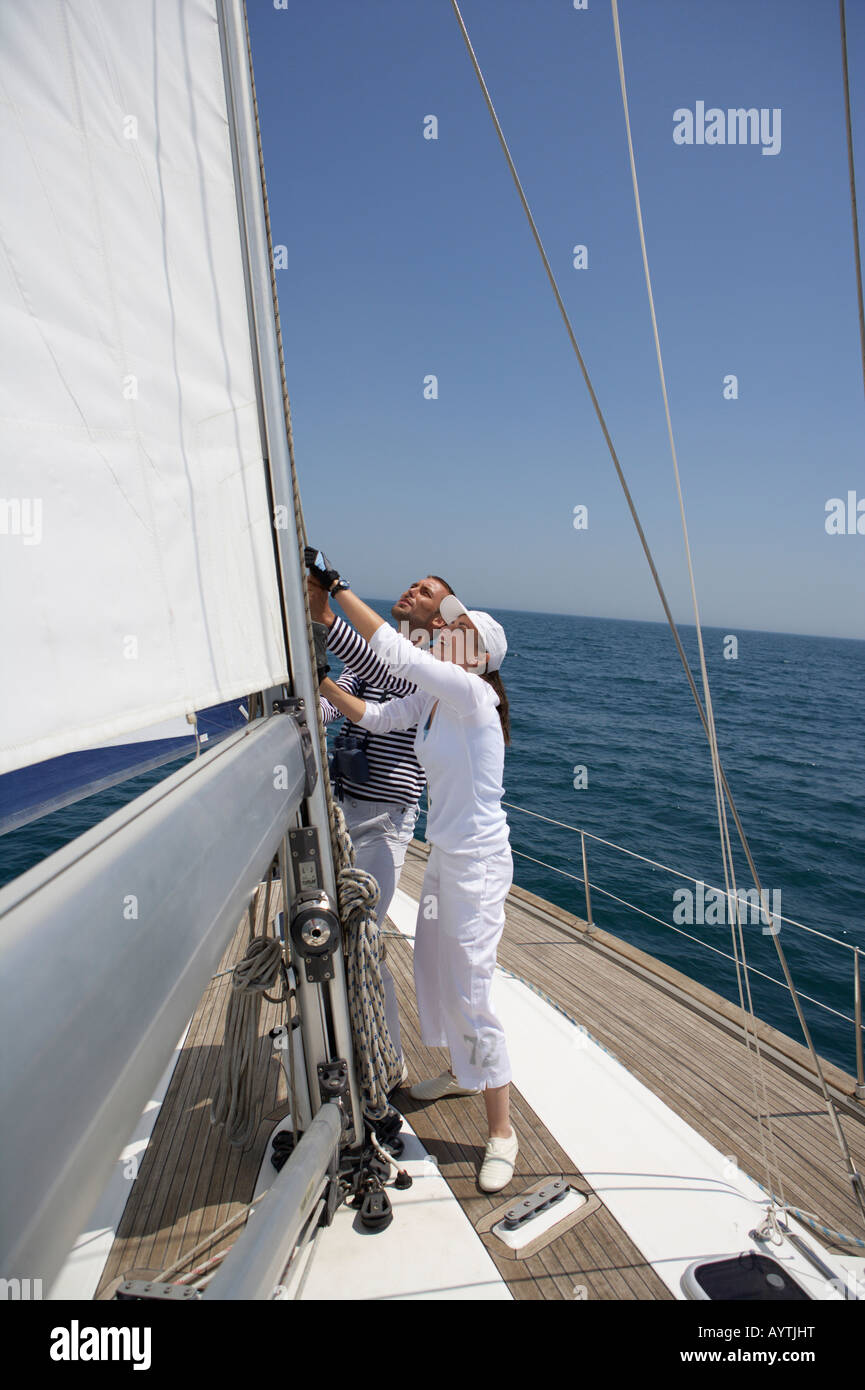 Two people working on a sailing yacht Stock Photo - Alamy