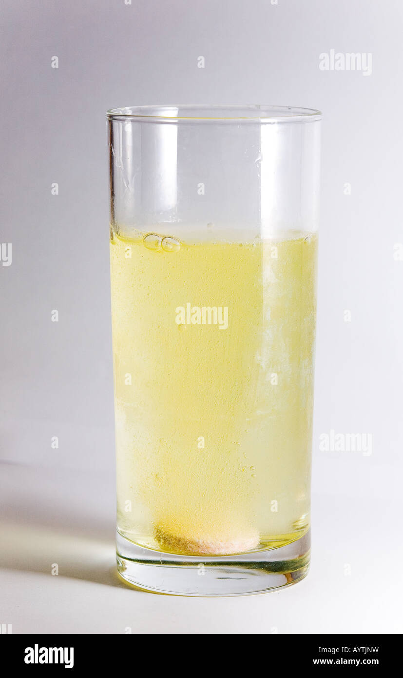 Yellow effervescent tablet dissolving in water Stock Photo - Alamy