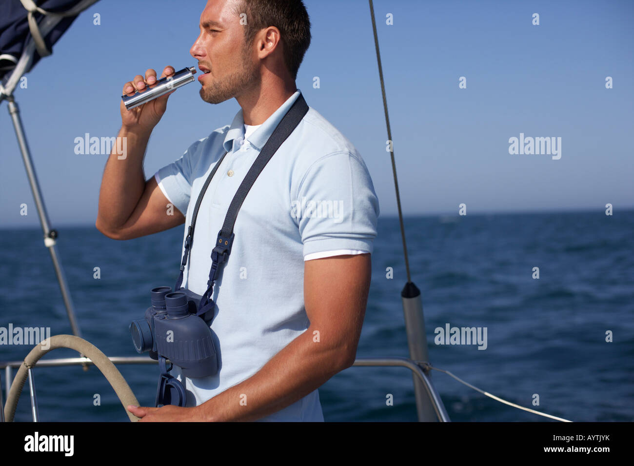 Man drinking from a pocket flask, side view, truncated Stock Photo - Alamy