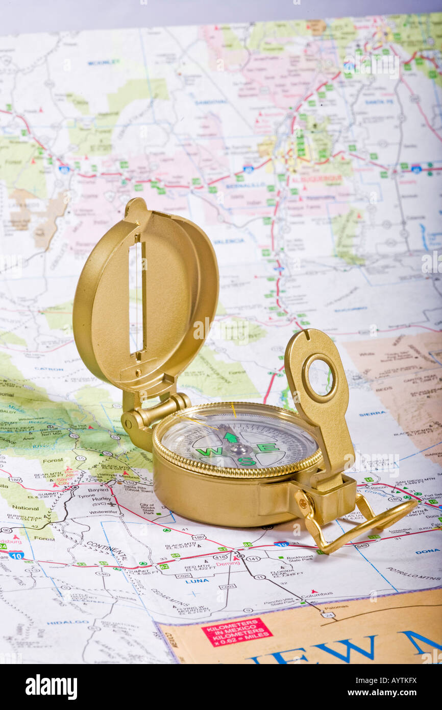 Gold colored compass on a topographic map Stock Photo - Alamy