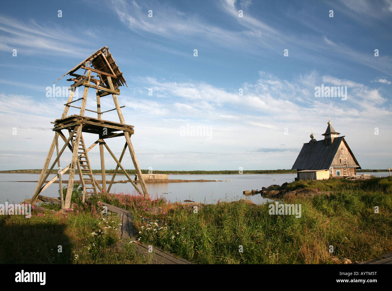 Wooden watchtower and an orthodox church at the White Sea coast near ...