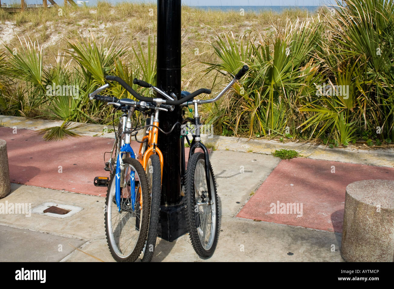 Bicycles leaning on a lamp post on the boardwalk Stock Photo - Alamy