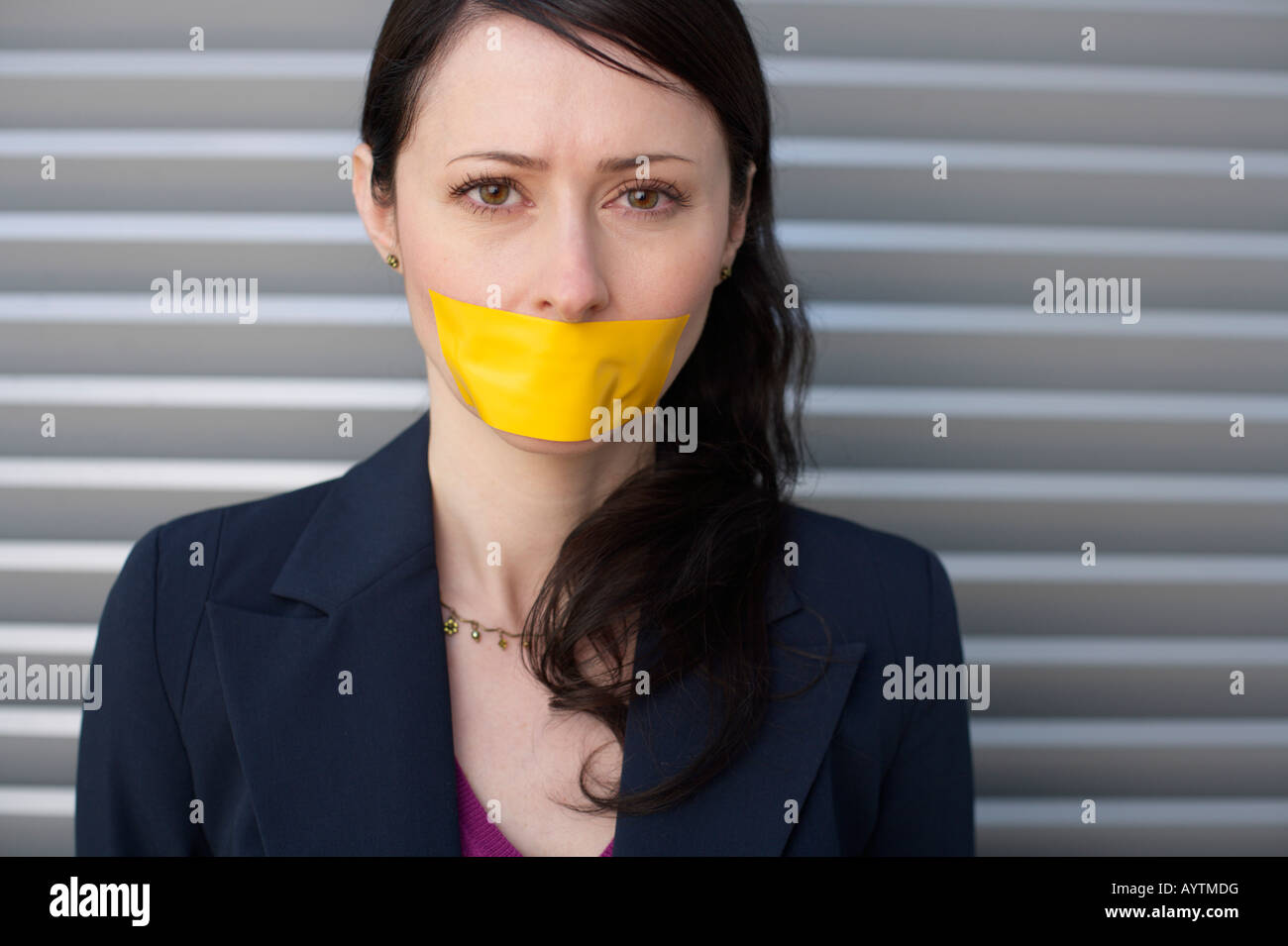Woman with tape over mouth hi-res stock photography and images - Alamy