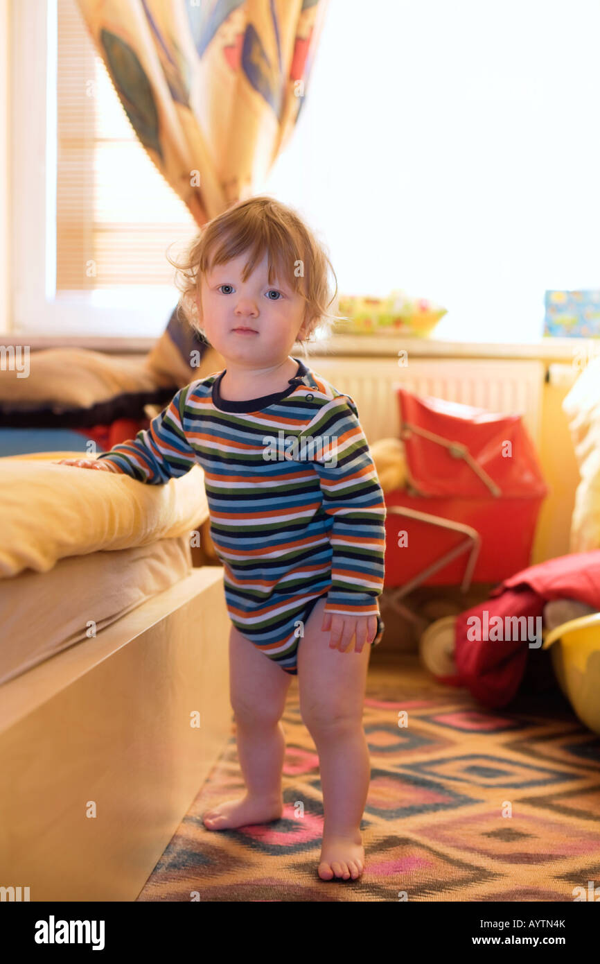 BOY STANDING BY THE BED Stock Photo - Alamy