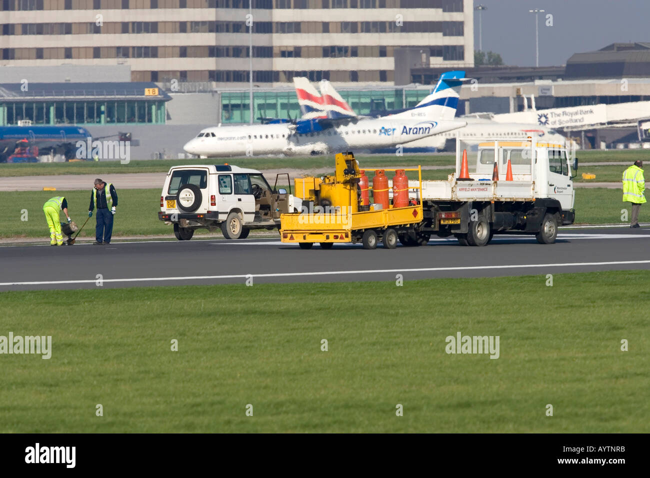 Airfield maintenance airport workers plant machinery Stock Photo - Alamy