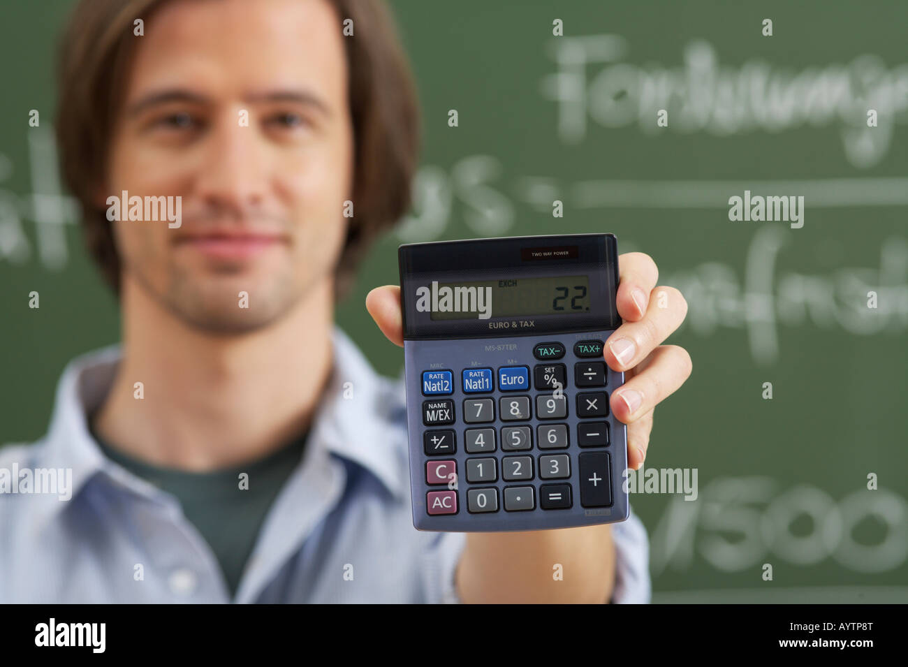A Man is holding a calculator in his hand Stock Photo - Alamy